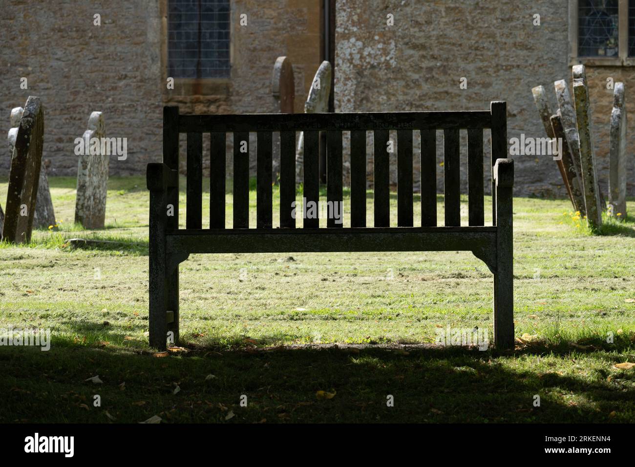 A bench in St. John the Baptist churchyard, Cherington, Warwickshire ...