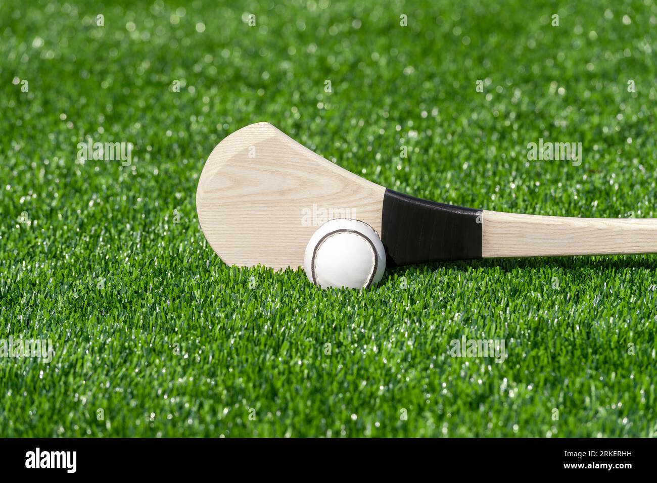 Hurling bat and sloitar on green grass. Horizontal sport theme poster ...