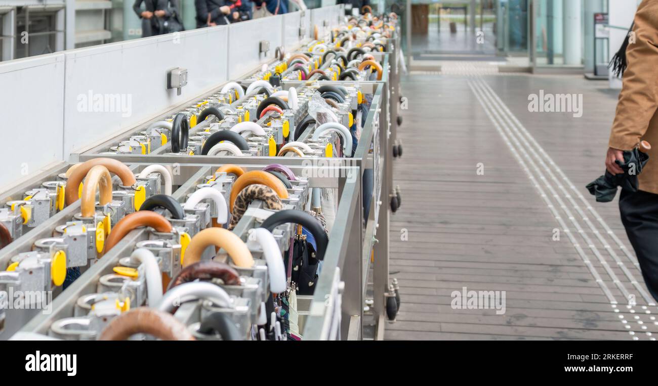 Individual lockable umbrella stand with colourful umbrellas inside a ...