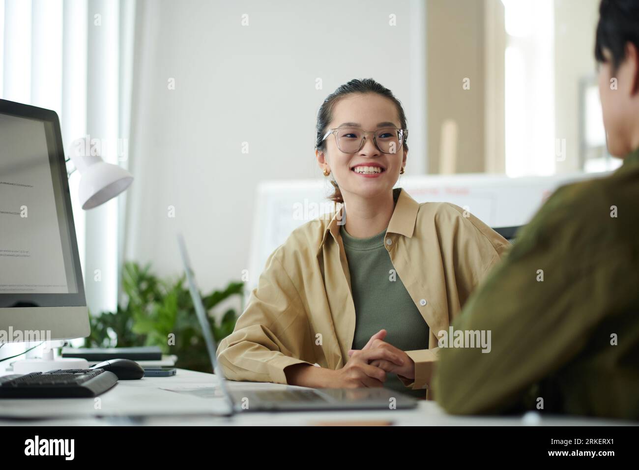 Cheerful young software developer discussing ideas with coworker Stock ...