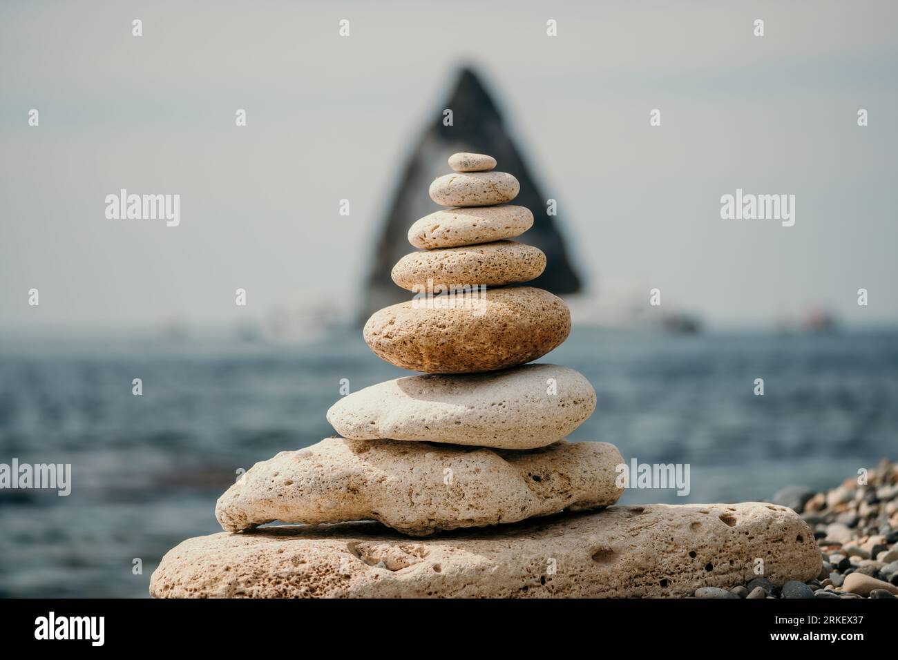 balanced rock pyramid on the pebbled beach is a study in harmony and ...