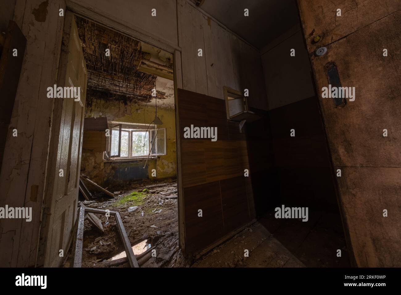 Old room with broken ceiling shabby brick walls and arched doorway ...