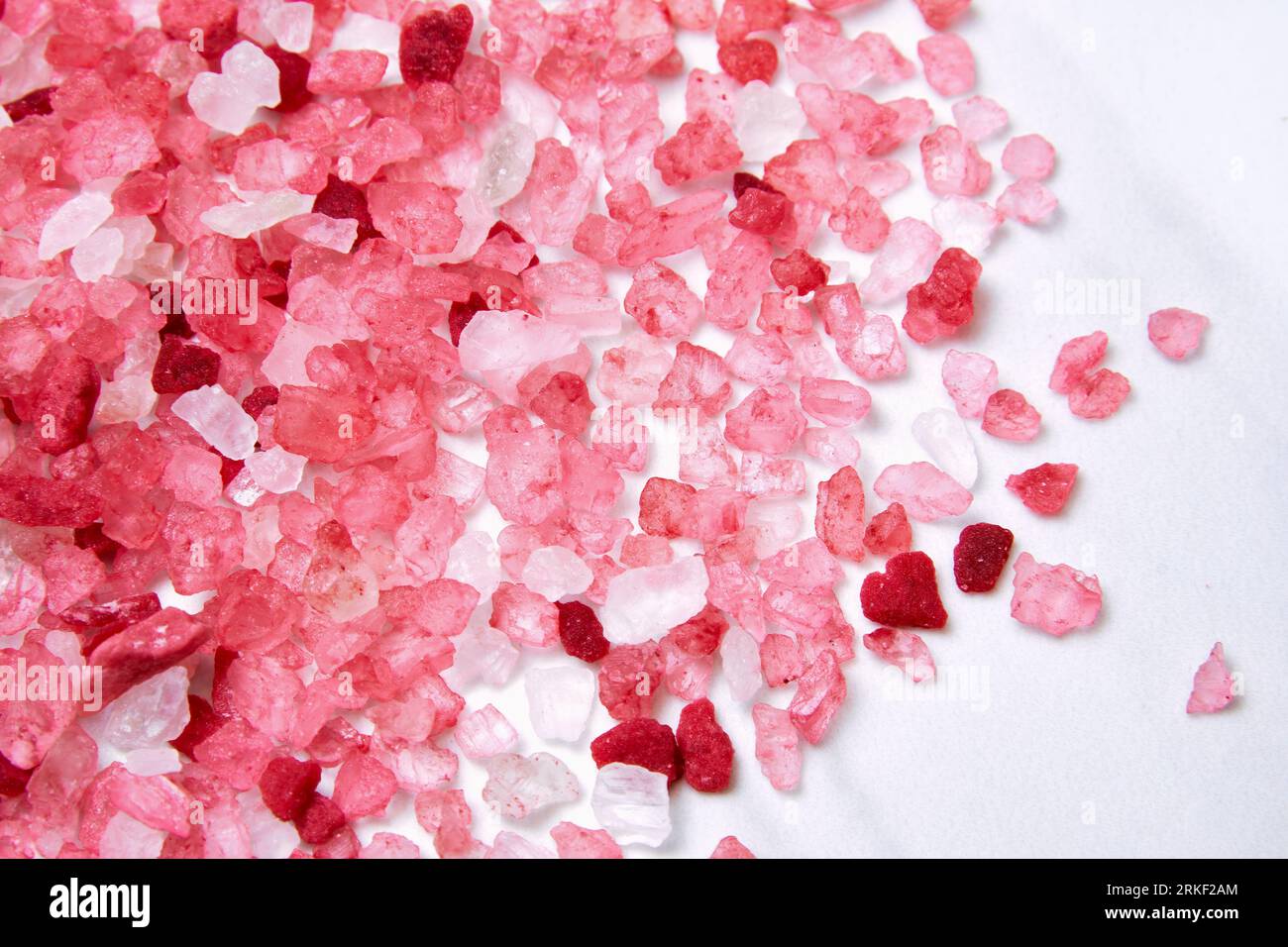 Texture with big rough pink bath salt grain scattered on the marble ...