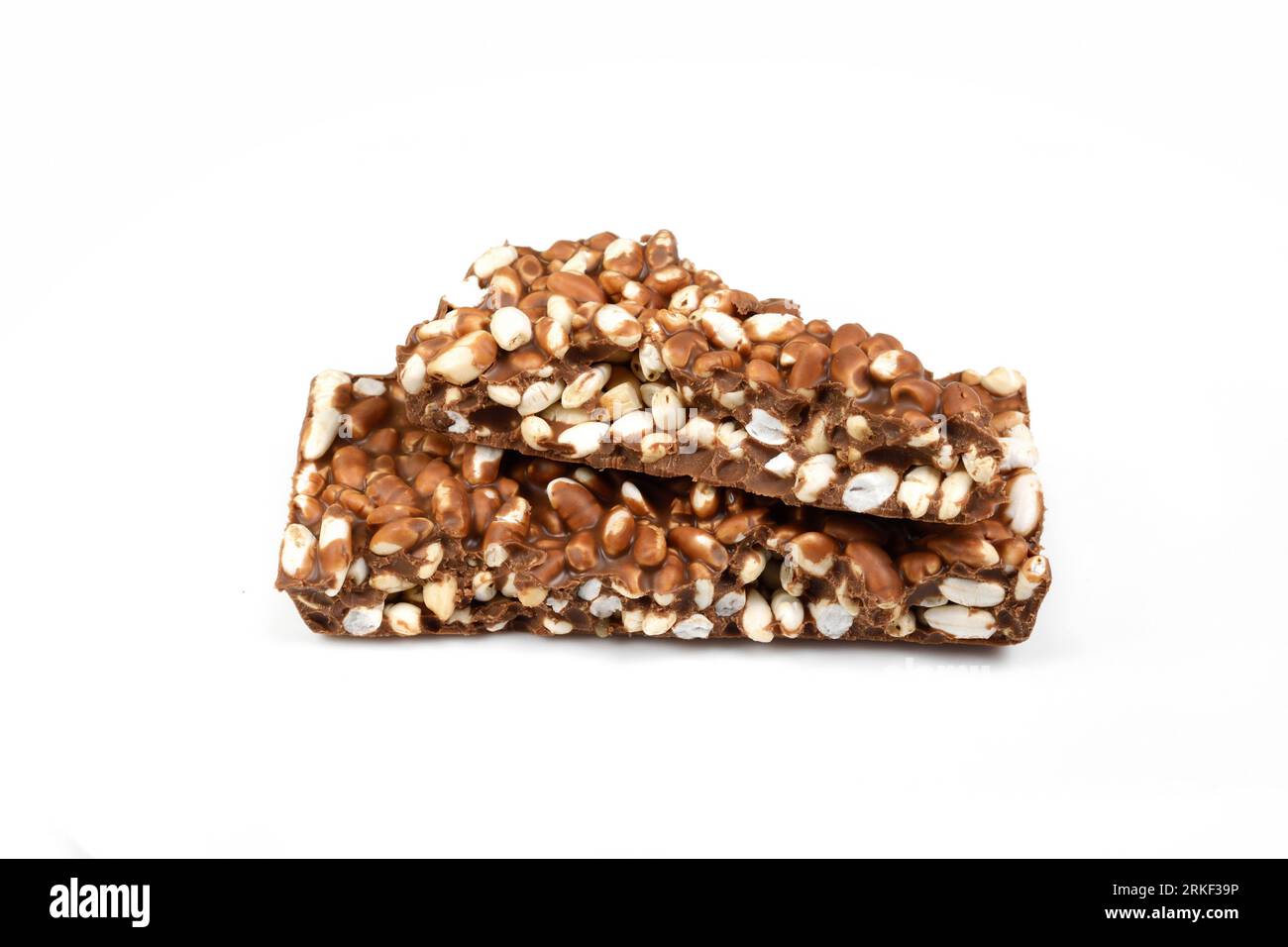 Chunks of milk chocolate with puffed rice isolated on white background ...
