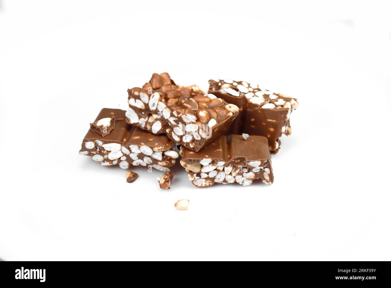 Chunks of milk chocolate with puffed rice isolated on white background ...