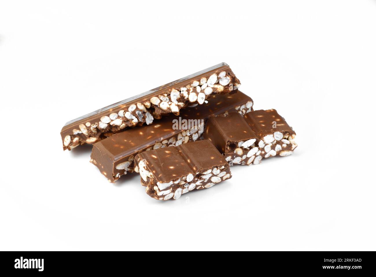 Chunks of milk chocolate with puffed rice isolated on white background ...
