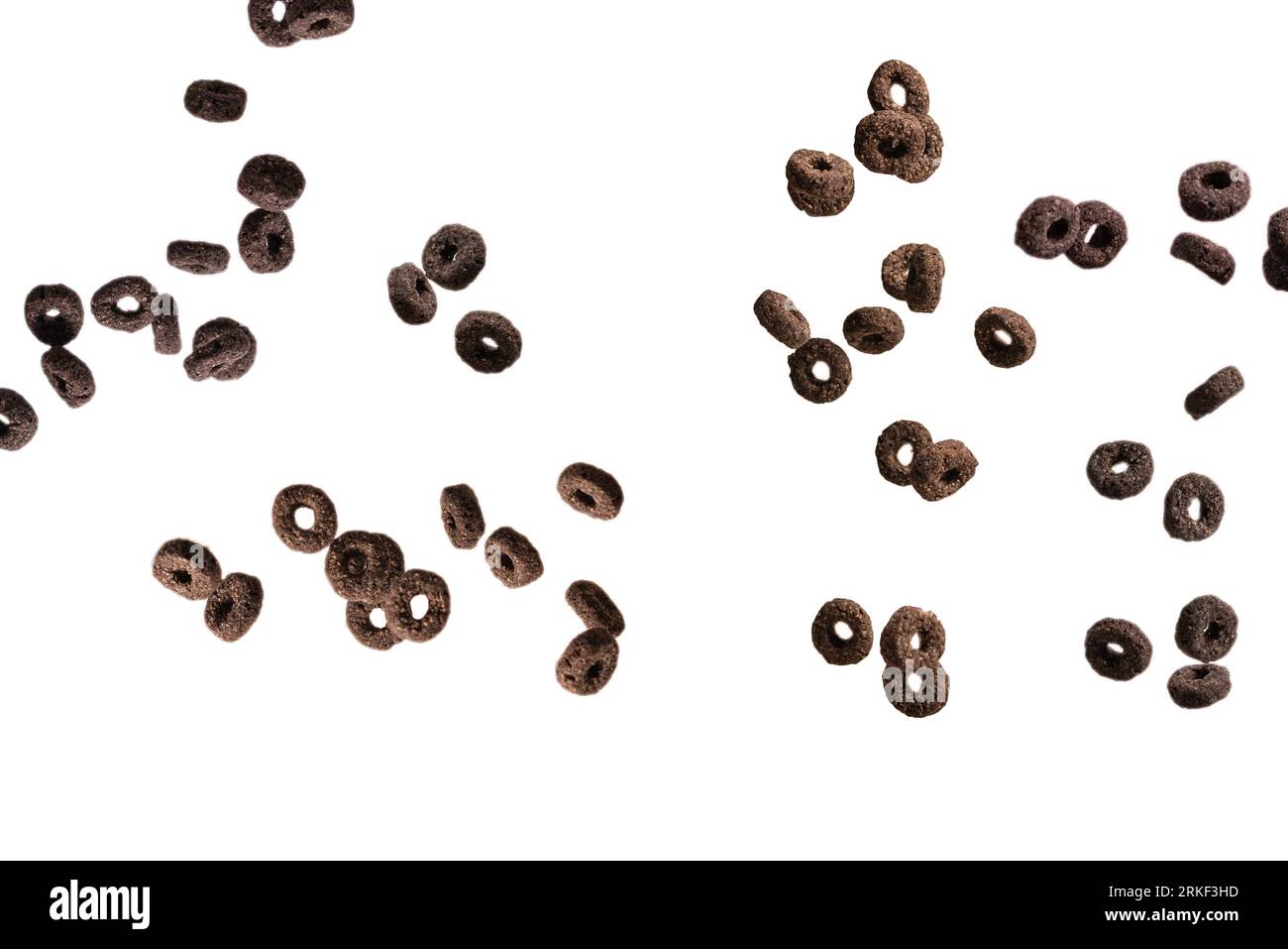 Chocolate rings cereal spill out into a bowl. Breakfast. Isolated on a ...