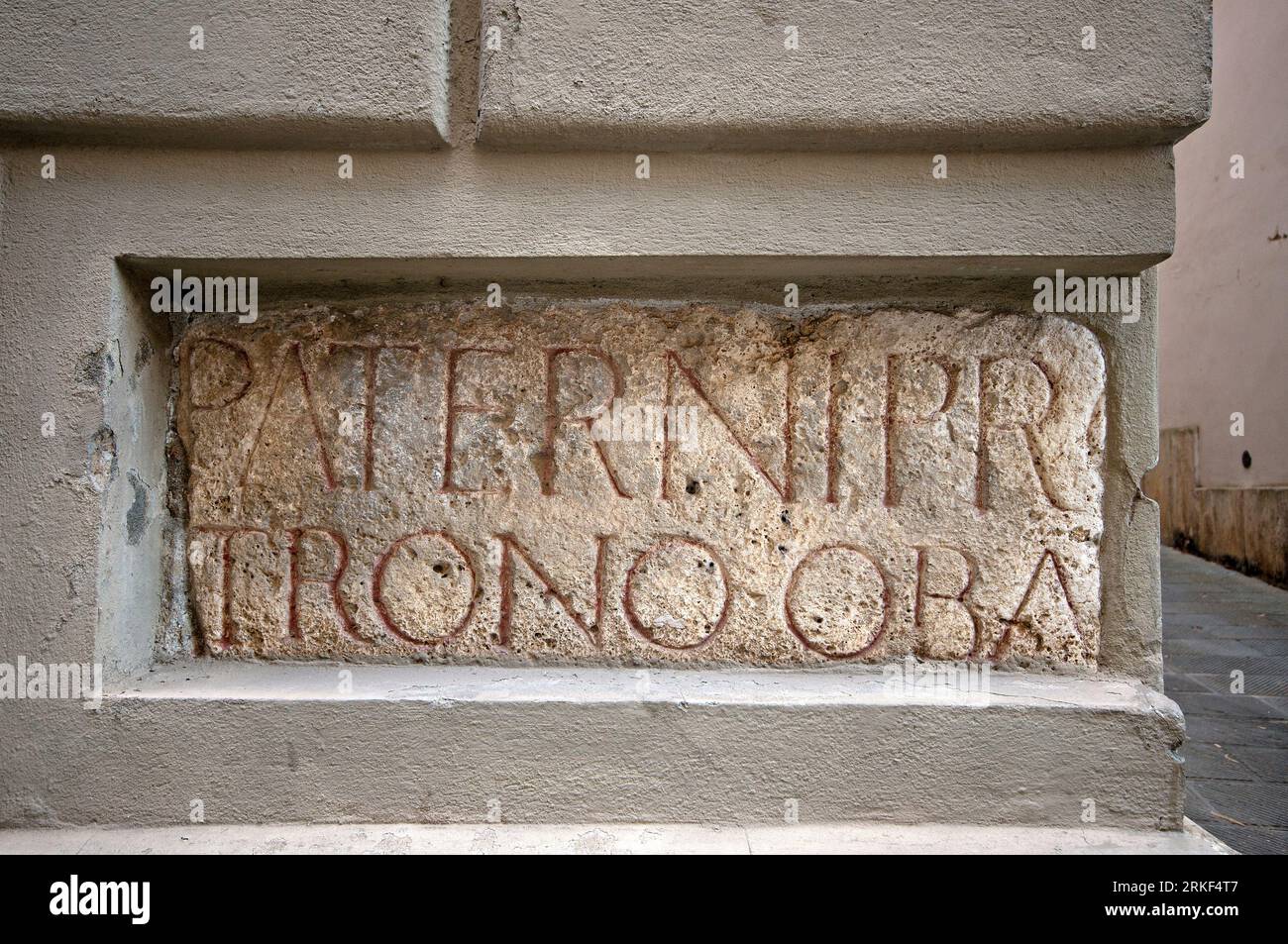 Ancient latin inscription (PATER NIPR TRONO OBA) engraved in the stone ...