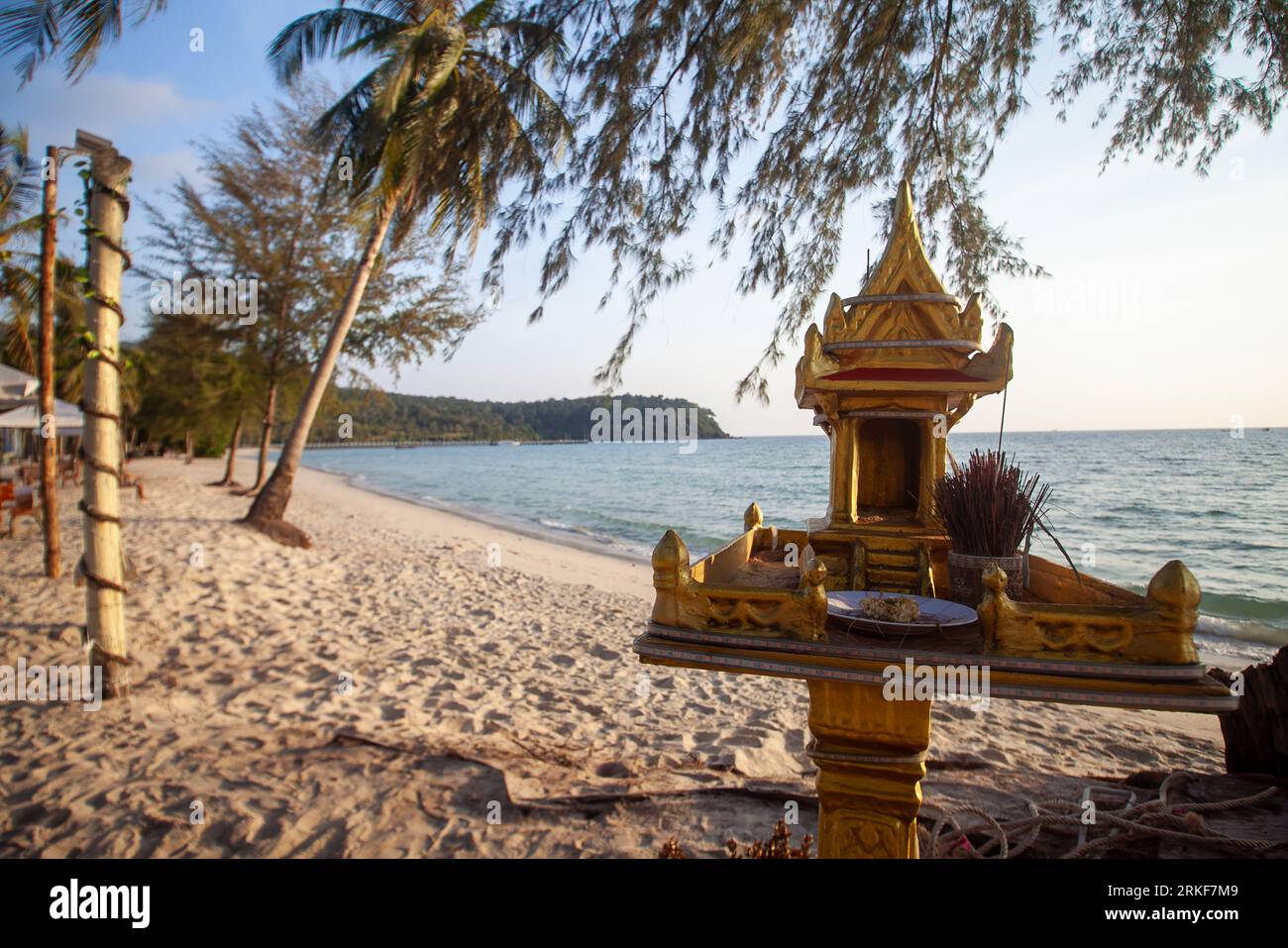 A small, golden Buddhist altar standing on a picturesque beach Stock ...