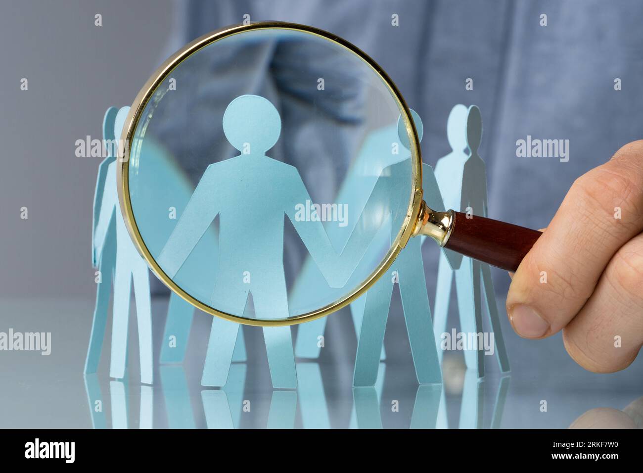 Helping hand with magnifying glass hi-res stock photography and images ...