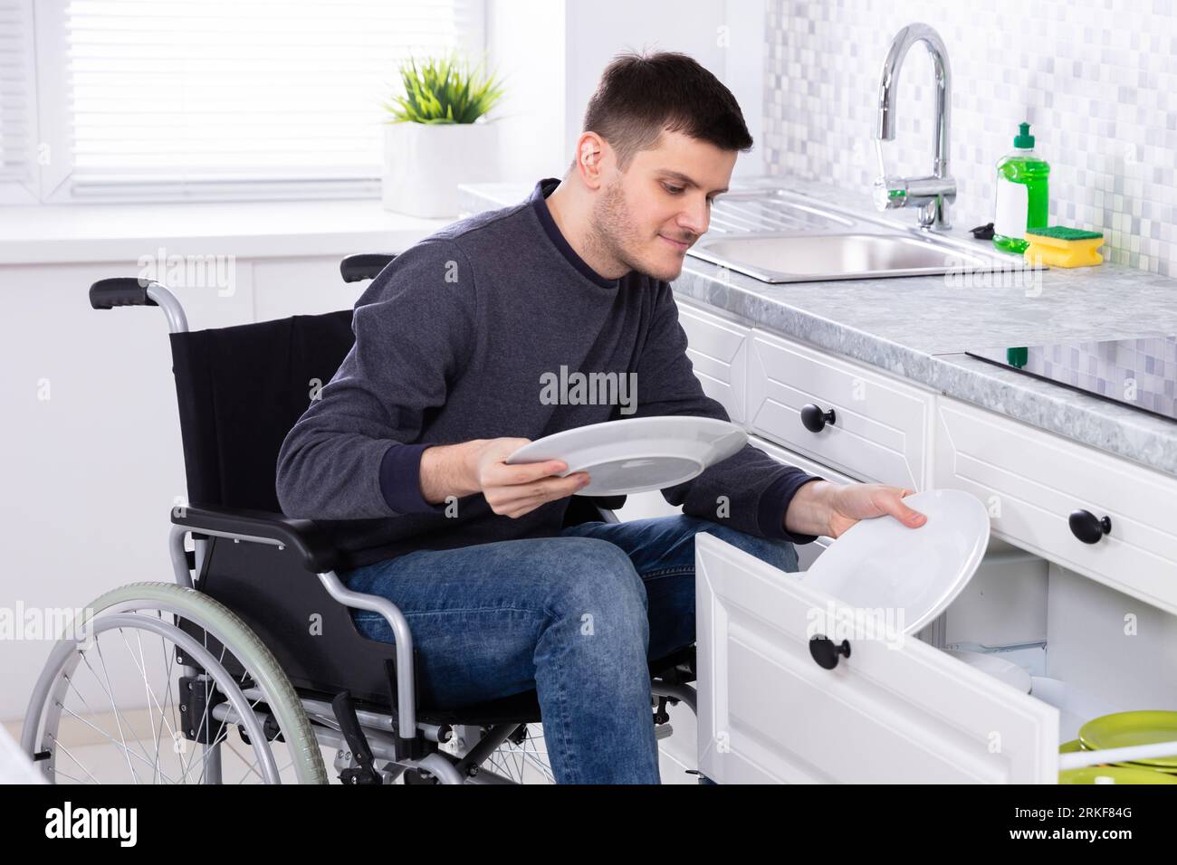 Man in wheelchair putting hi-res stock photography and images - Alamy