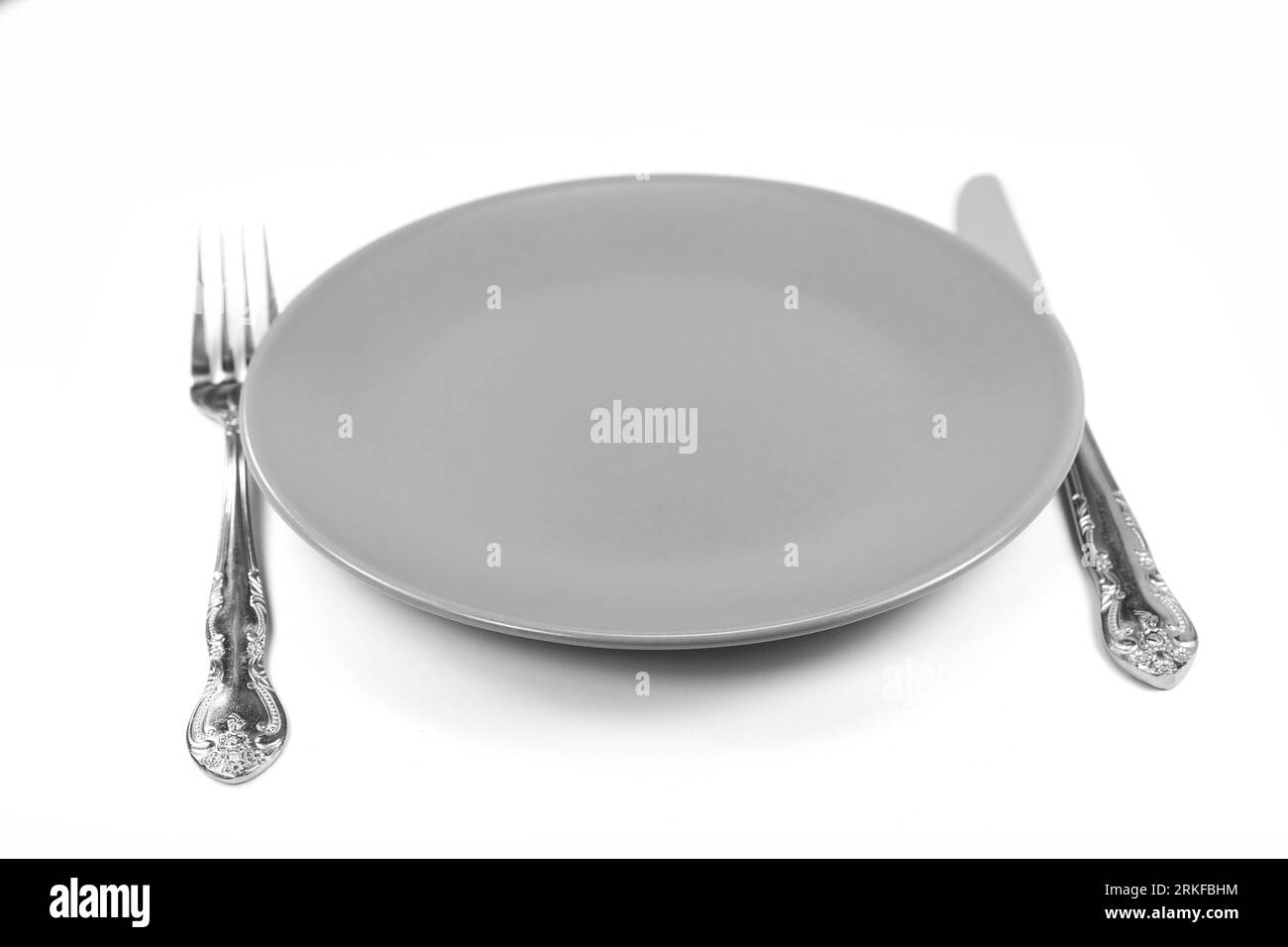 Plate fork knife blue background Black and White Stock Photos & Images - Alamy