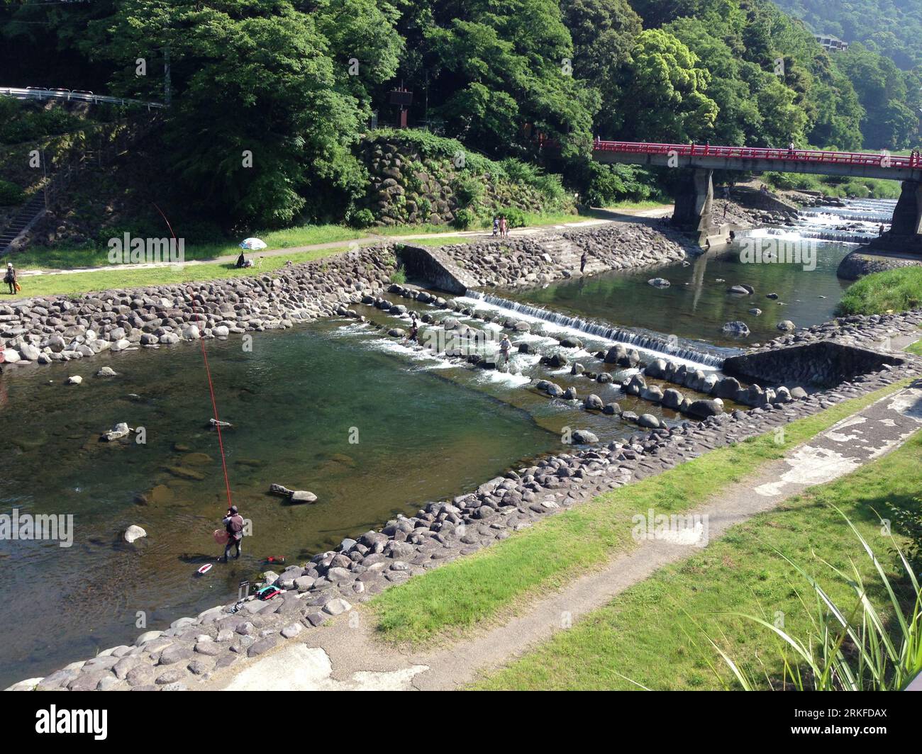 A bridge crossing over a river in Hakone-Yumoto, Japan, surrounded by ...