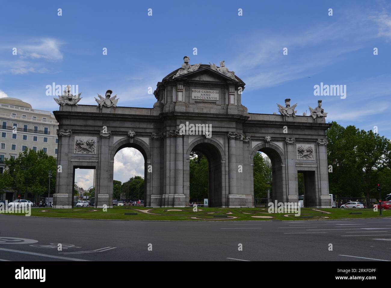 A stunning outdoor scene featuring a large stone arch situated in front ...