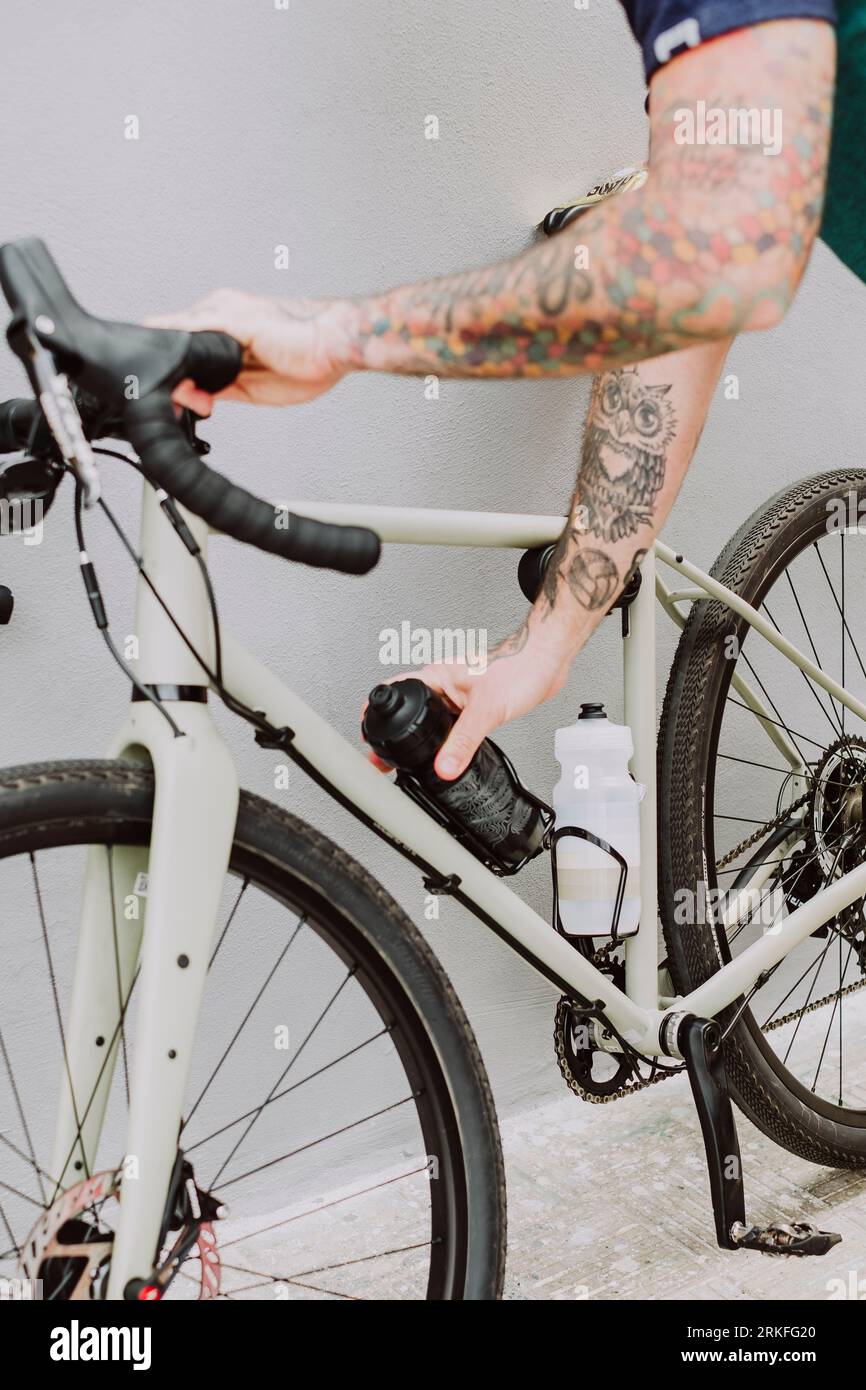 A man with his water bottles for te. cycling adventure route Stock ...