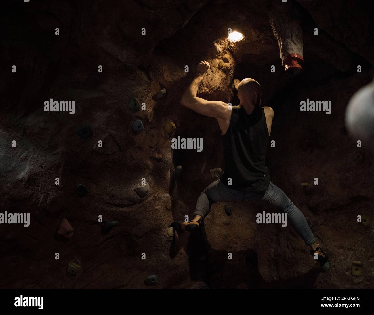 man at the top of a bouldering wall Stock Photo - Alamy