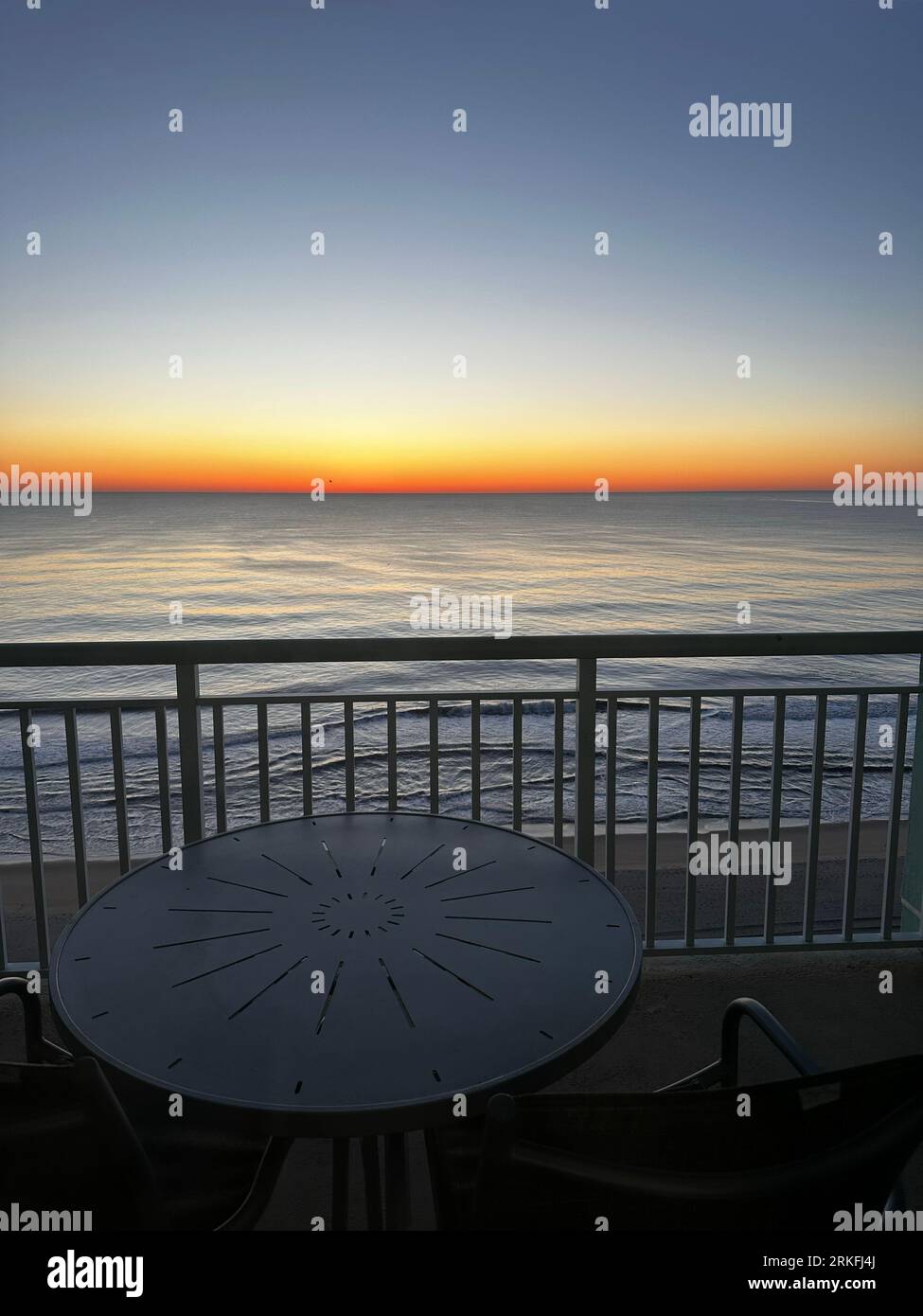 A spectacular sunset from the balcony of a luxurious oceanfront condo ...