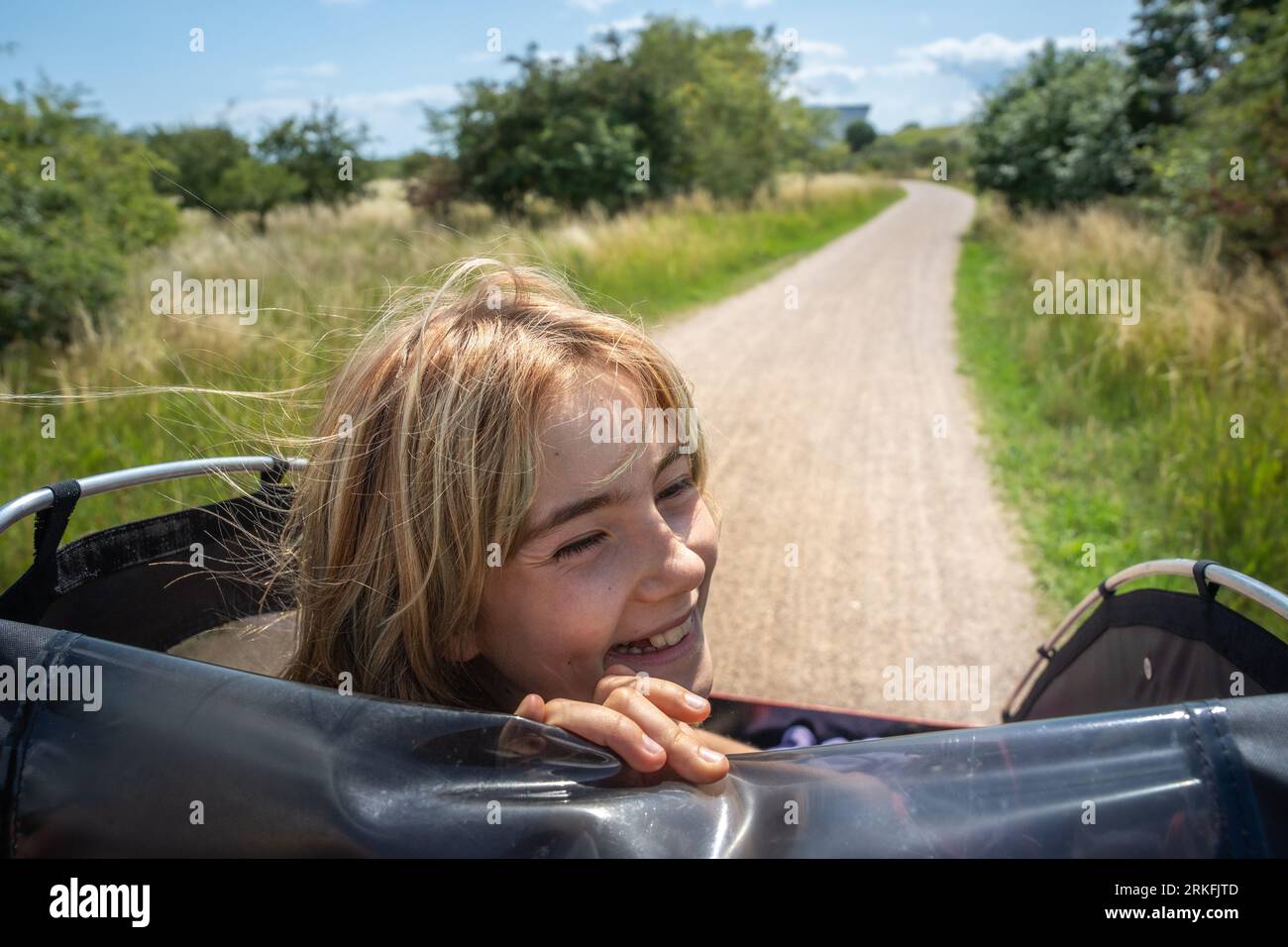 Girl Looking Back Smiling Riding on a Dirt Path in Denmark Stock Photo ...