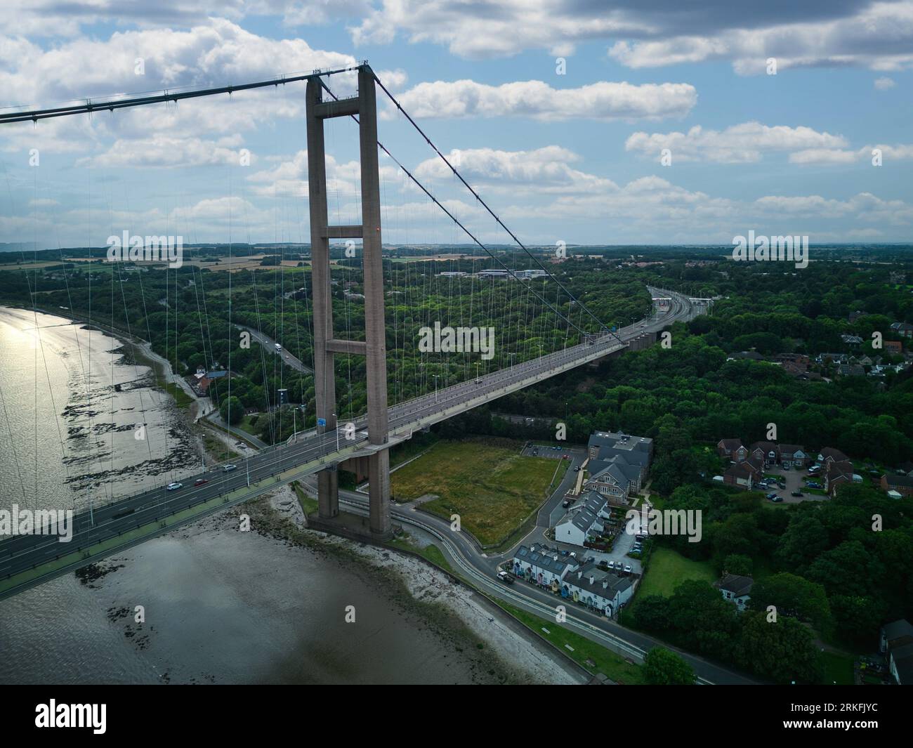 An aerial view of the Humber Bridge spanning across a river in a large ...