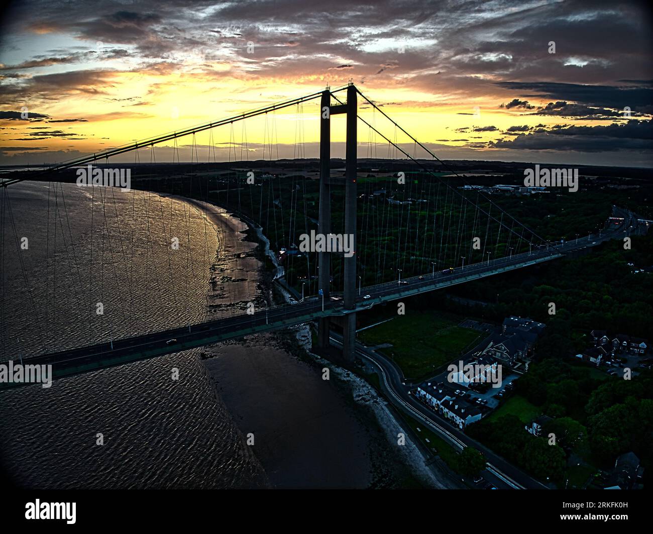 An aerial view of the Humber Bridge spanning across a river in a large ...