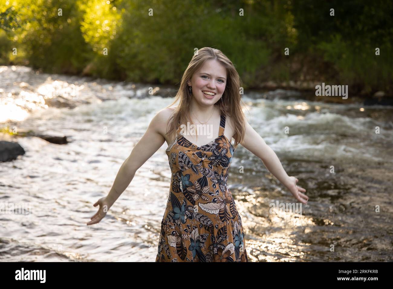 Teenage girl playing in stream Stock Photo - Alamy