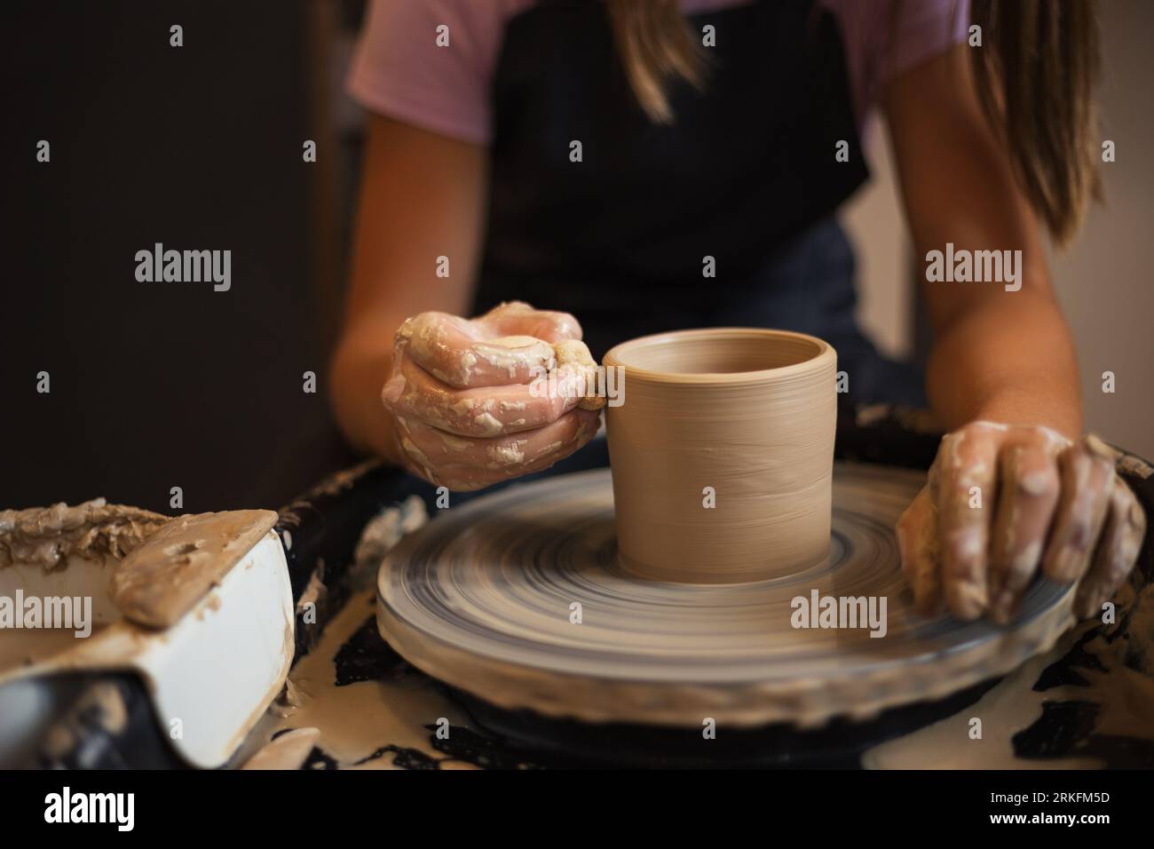 Close up of teenage girl's molds clay pot spinning on pottery wh Stock ...