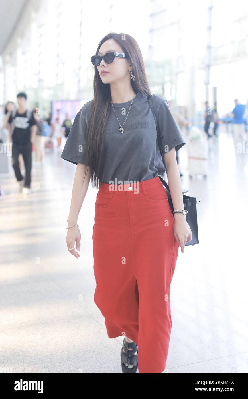 Chinese singer and actress Fei appears at the airport in Changsha City ...