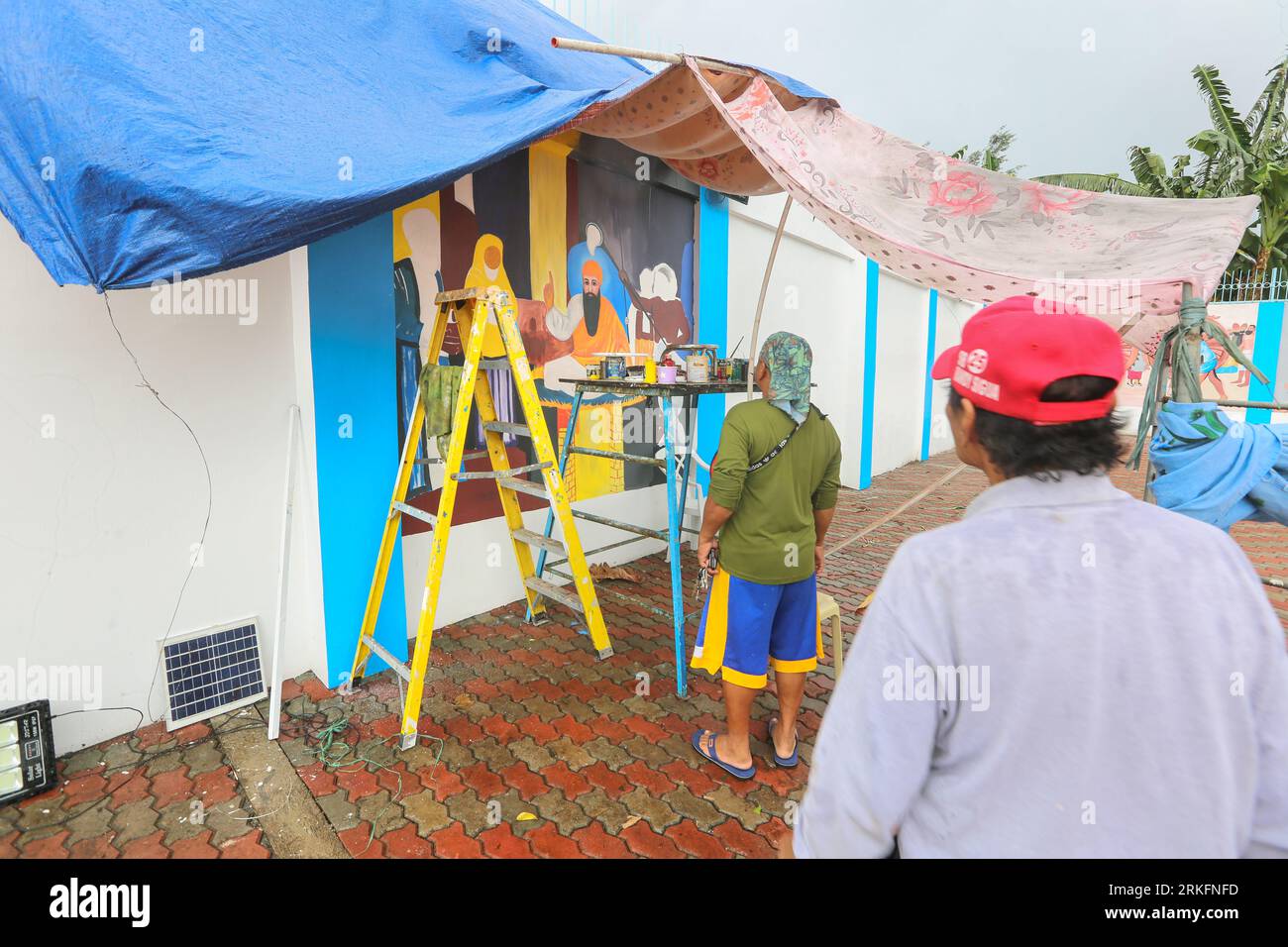 Filipino artists Noel Buenacifra Jr & Sr paint murals frescoes of the ...