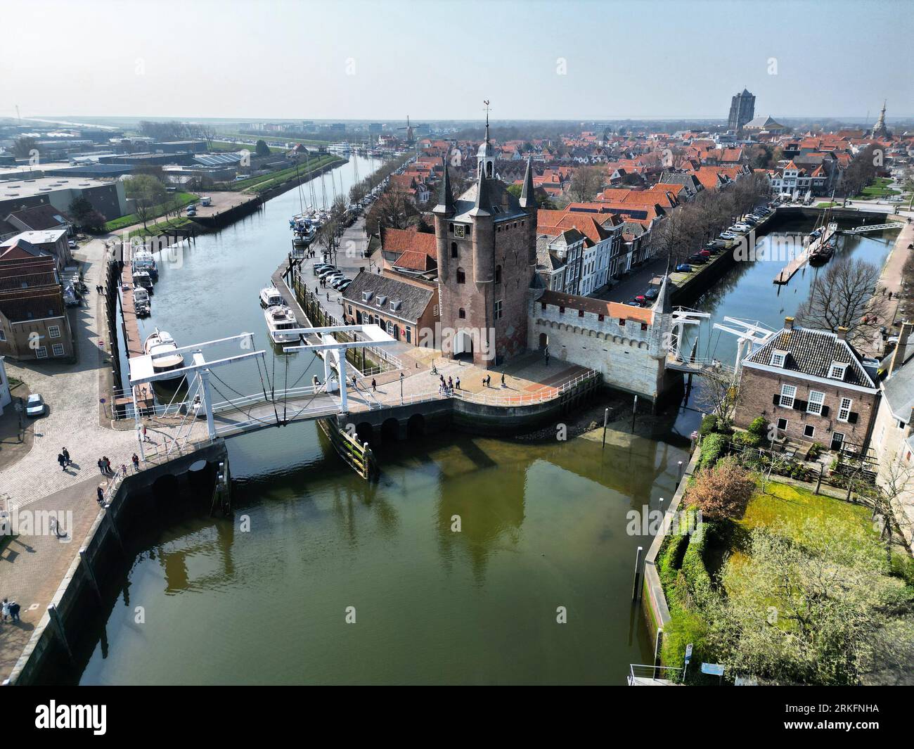 An aerial view of an urban cityscape features a canal with multiple ...
