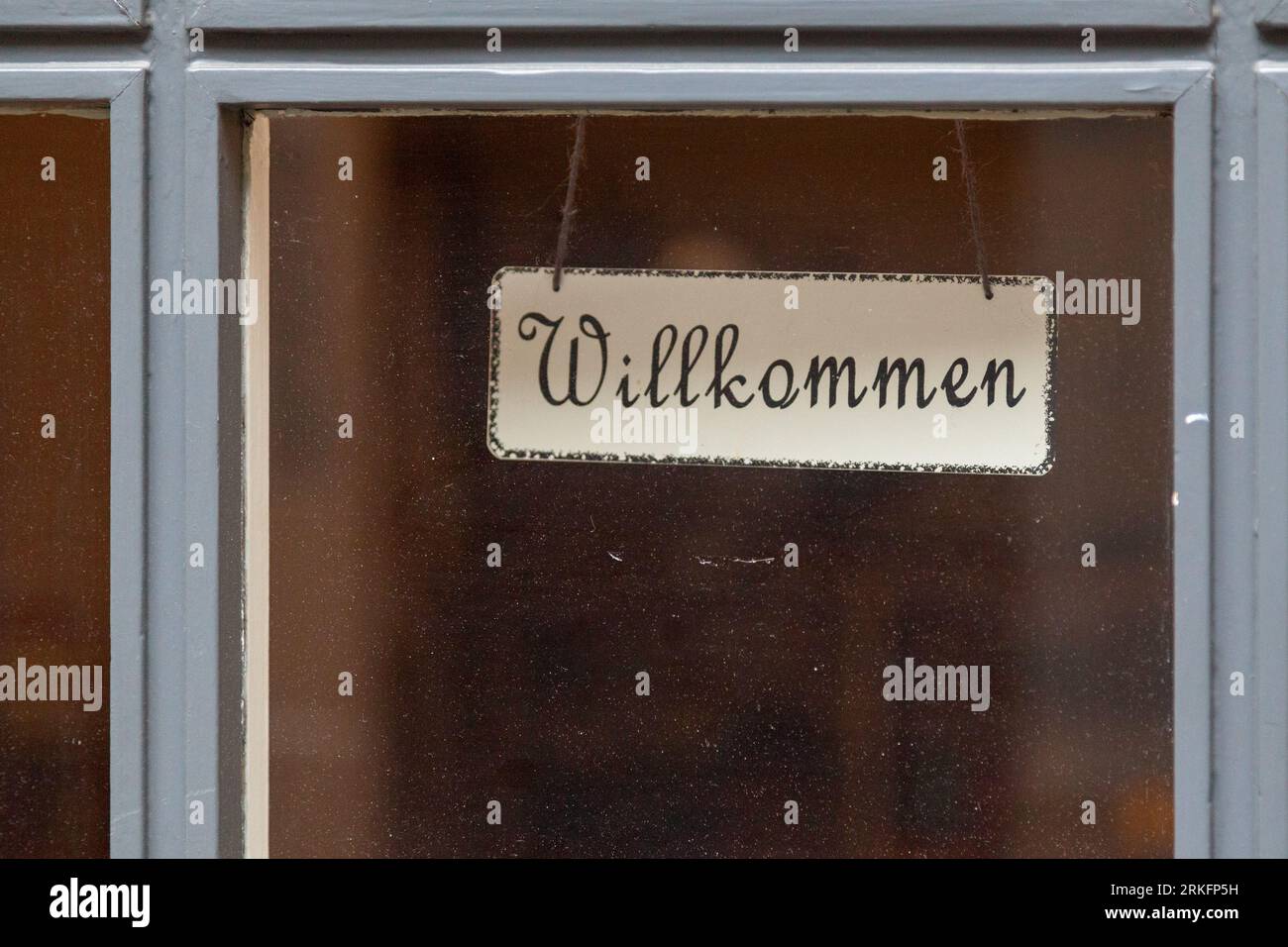 Close-up on a German welcome sign in the window Stock Photo - Alamy