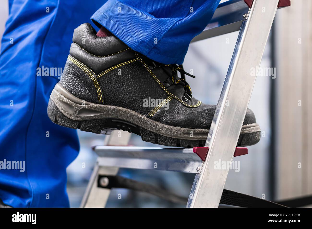 Low Section View Of A Handyman's Foot Climbing Ladder Stock Photo - Alamy