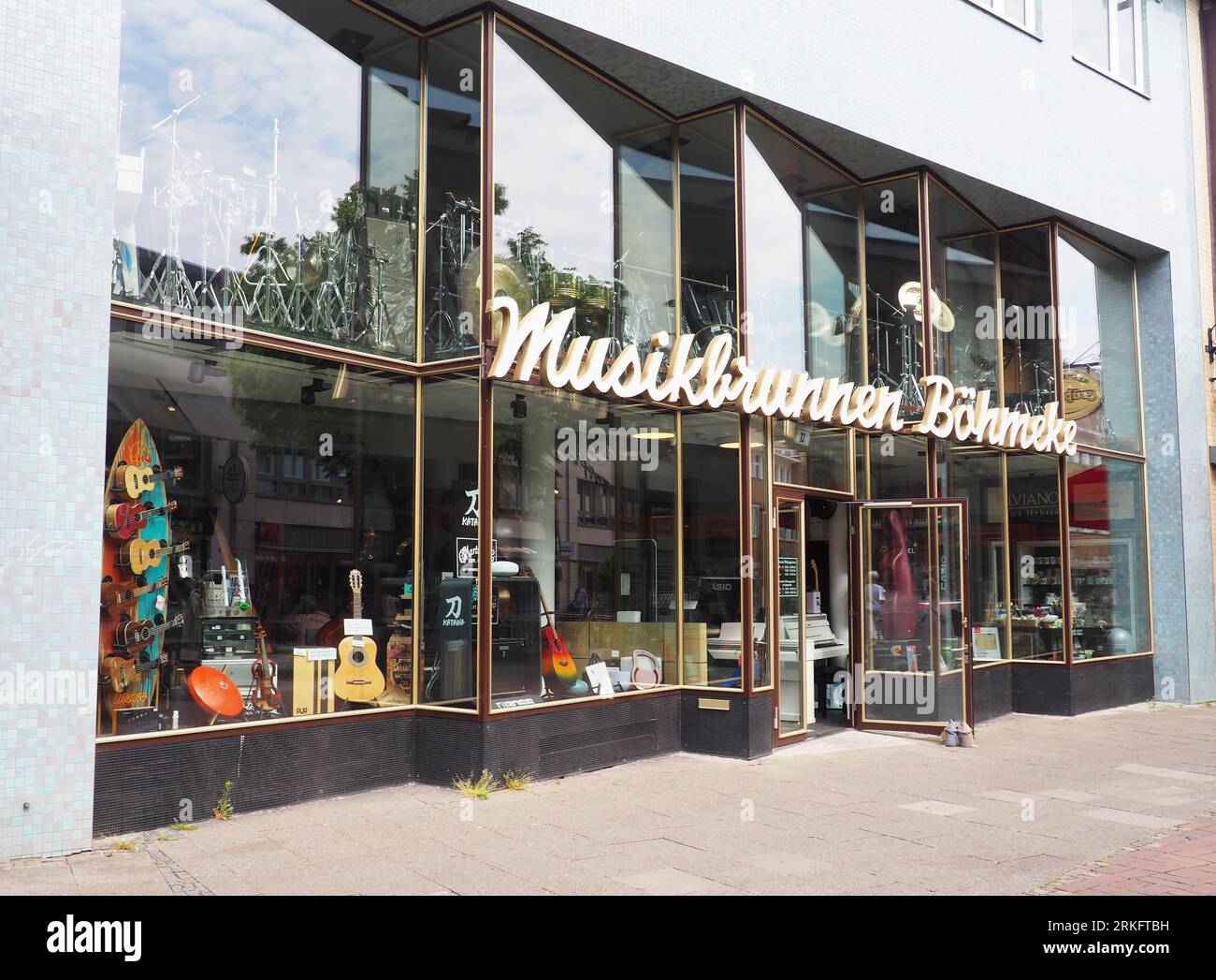 The Musikbrunnen Boehmeke music store with musical instruments, with a ...