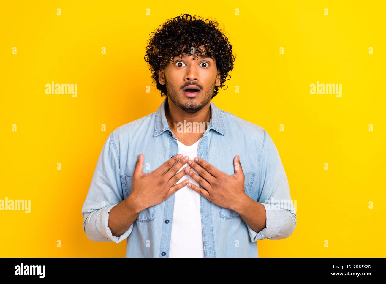 Portrait of impressed speechless young man arms touch chest open mouth ...
