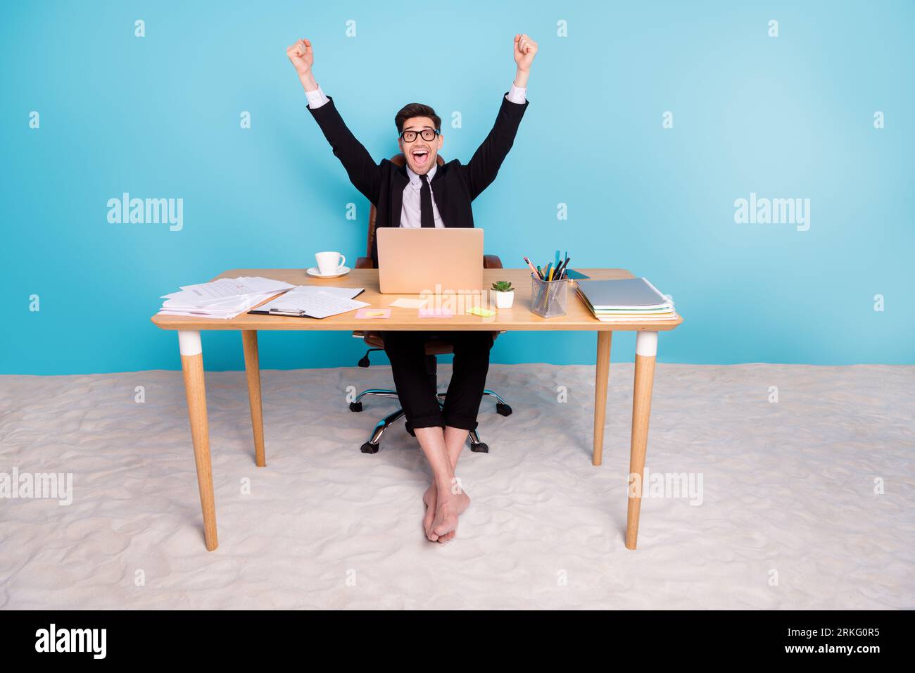Photo of excited worker guy sitting office desk raise fists up ...