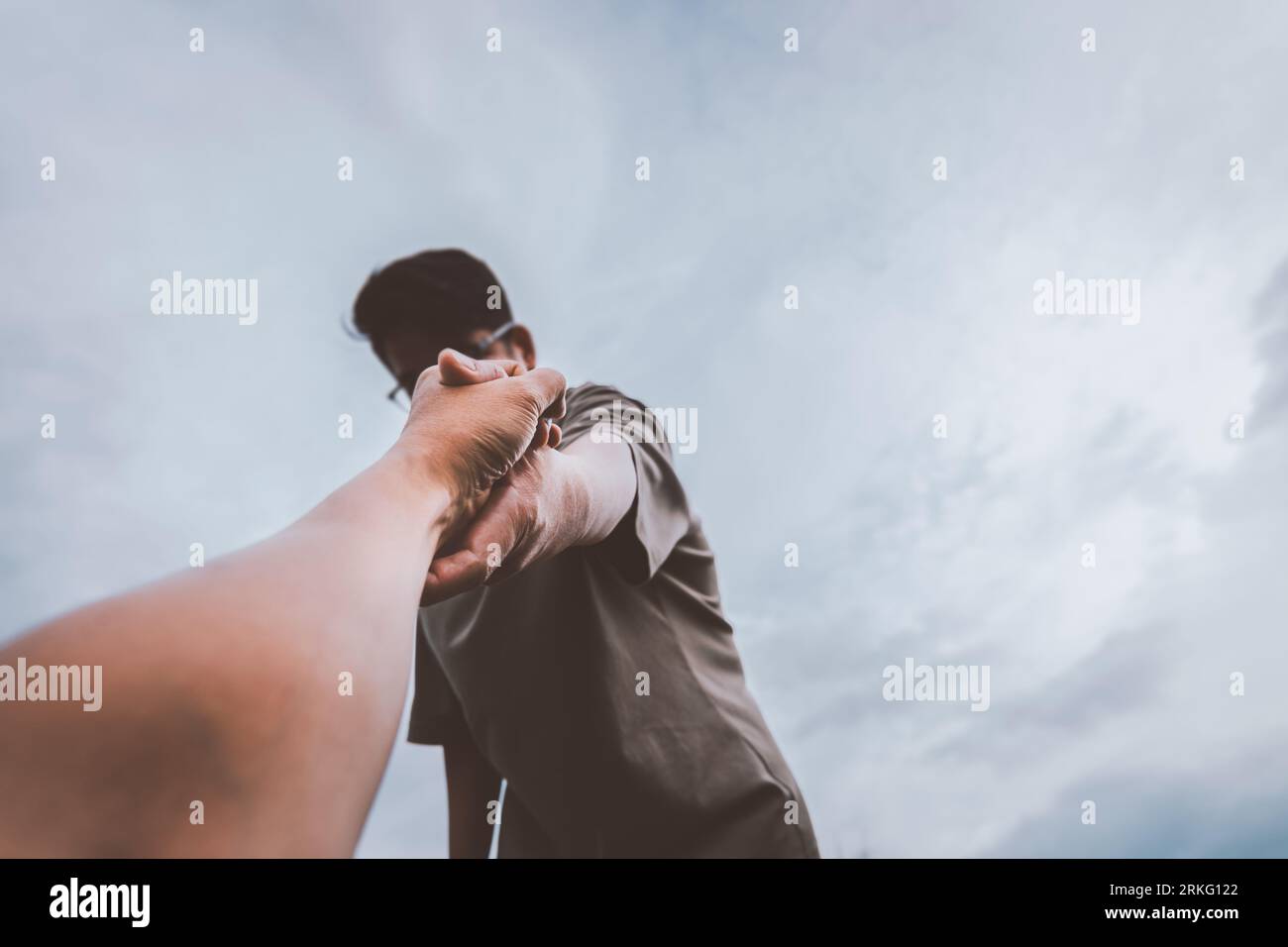 Help concept hands reaching out to help each other Stock Photo - Alamy