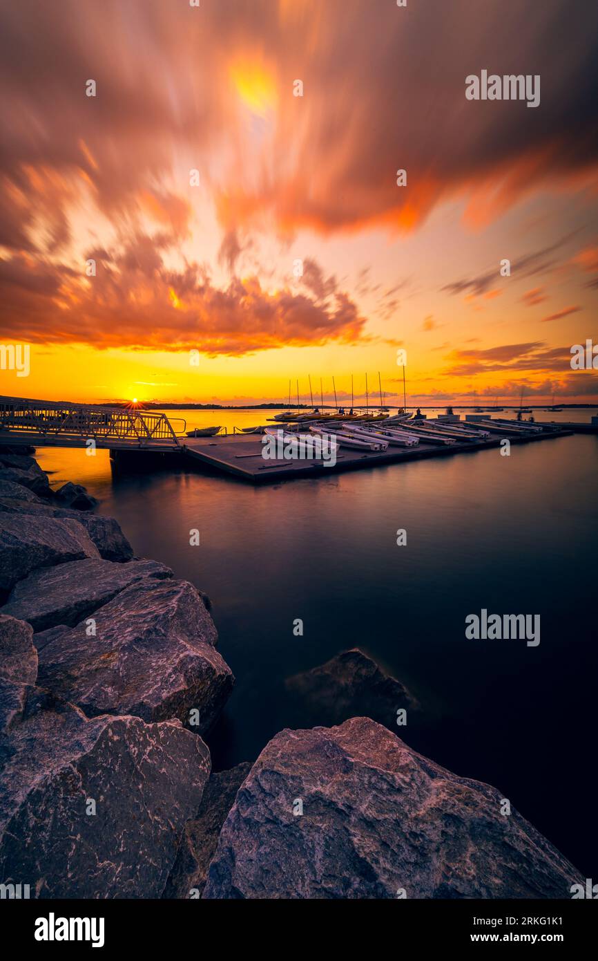 A majestic sunset over Lake Mendota with boats in the foreground in ...