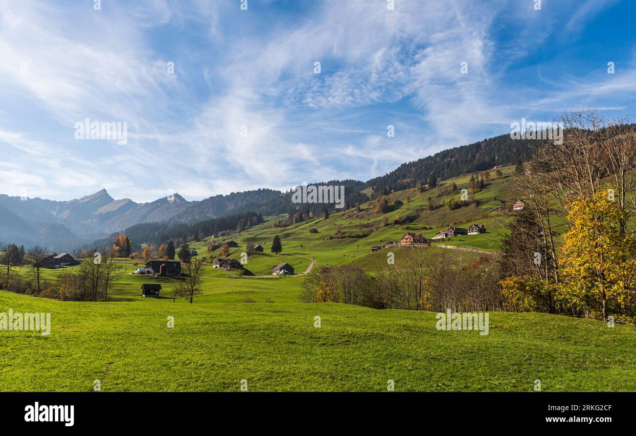 Landscape in the Toggenburg region with green meadows and farmhouses ...
