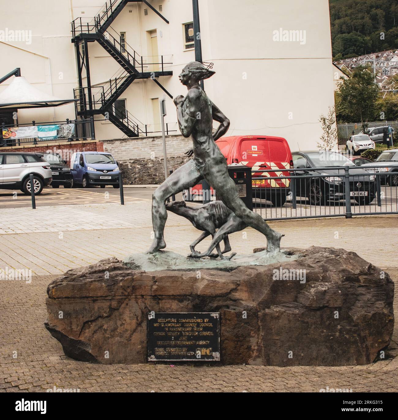 A closeup of a bronze statue of a young boy in a standing pose, located ...