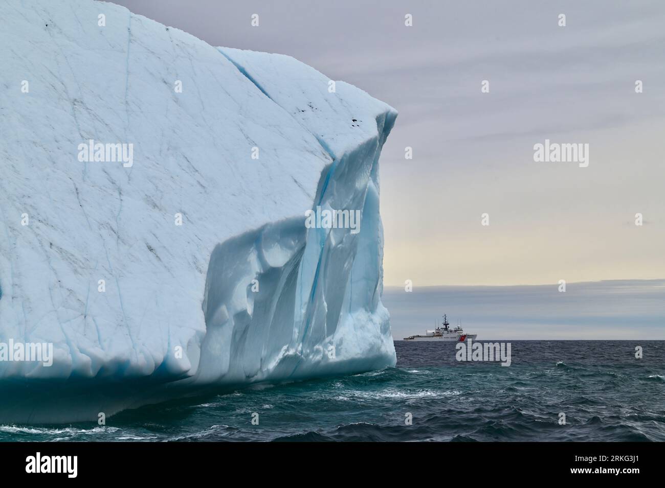 The U.S. Coast Guard Cutter Forward steams near an iceberg in the ...