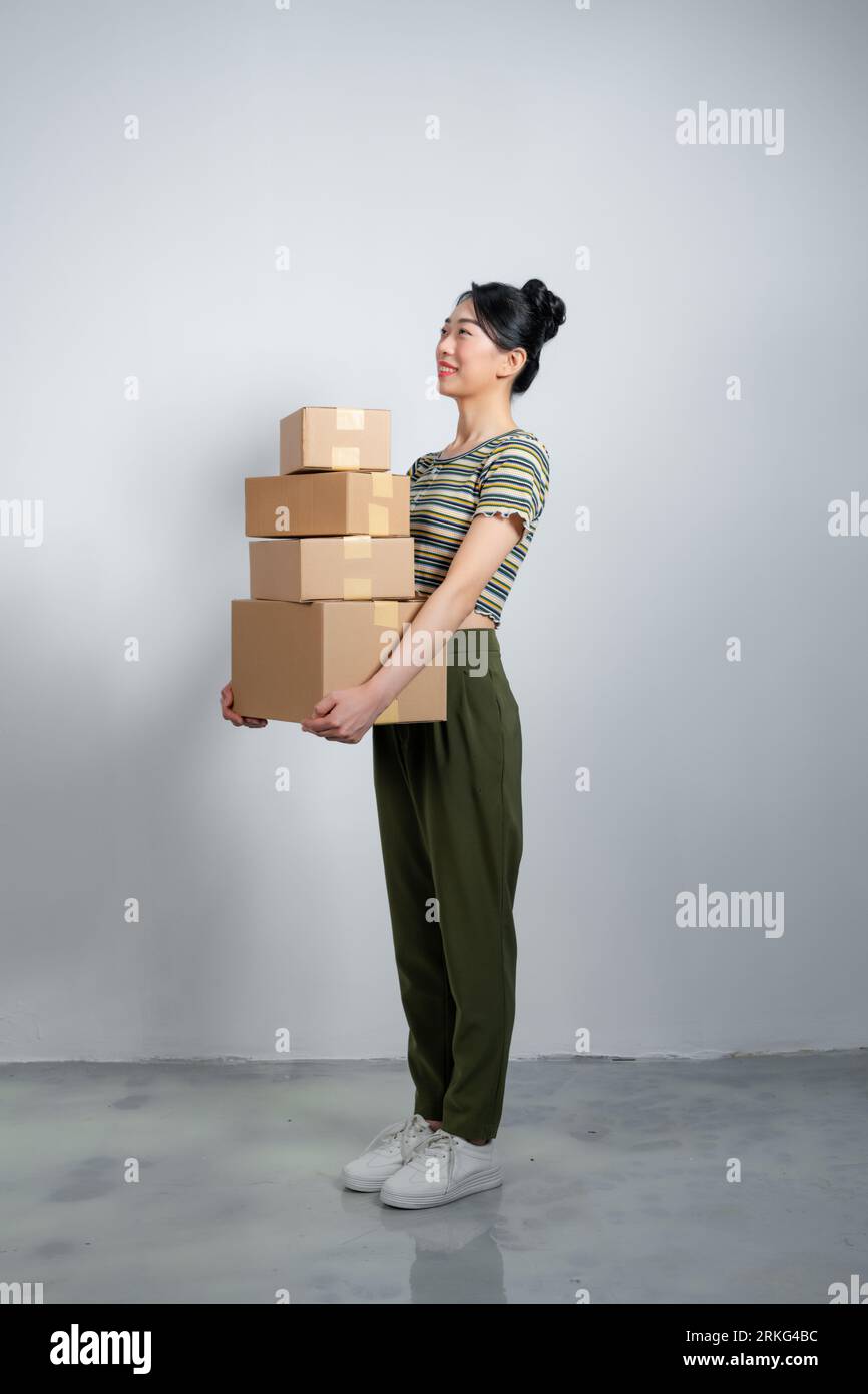 Portrait of beautiful happy woman carry boxes with orders Stock Photo ...