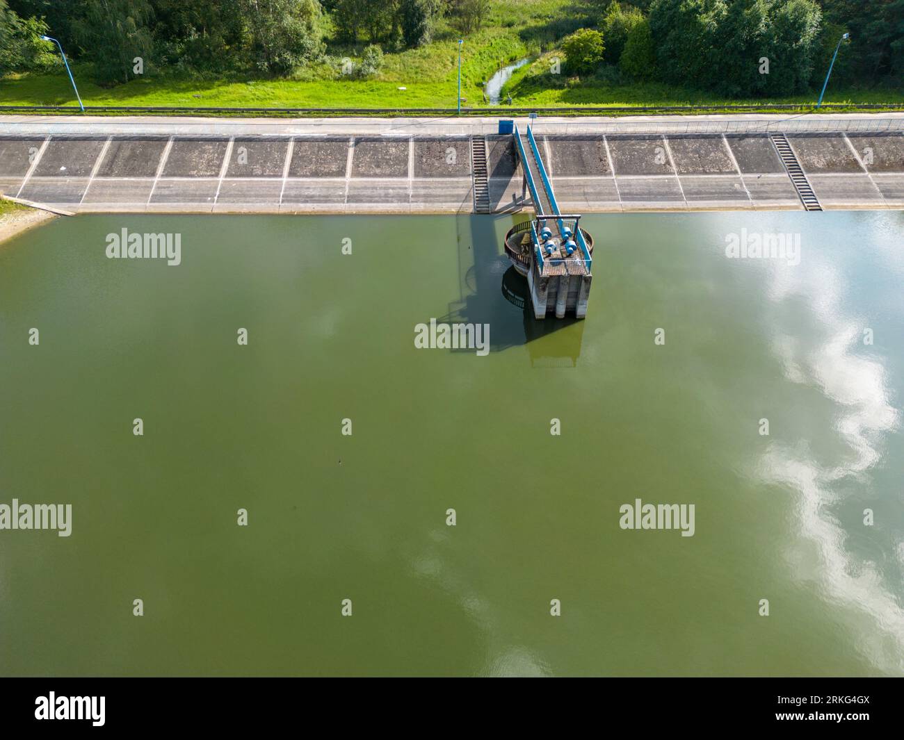 Aerial drone view of a concrete hydroelectric dam with a pump station ...