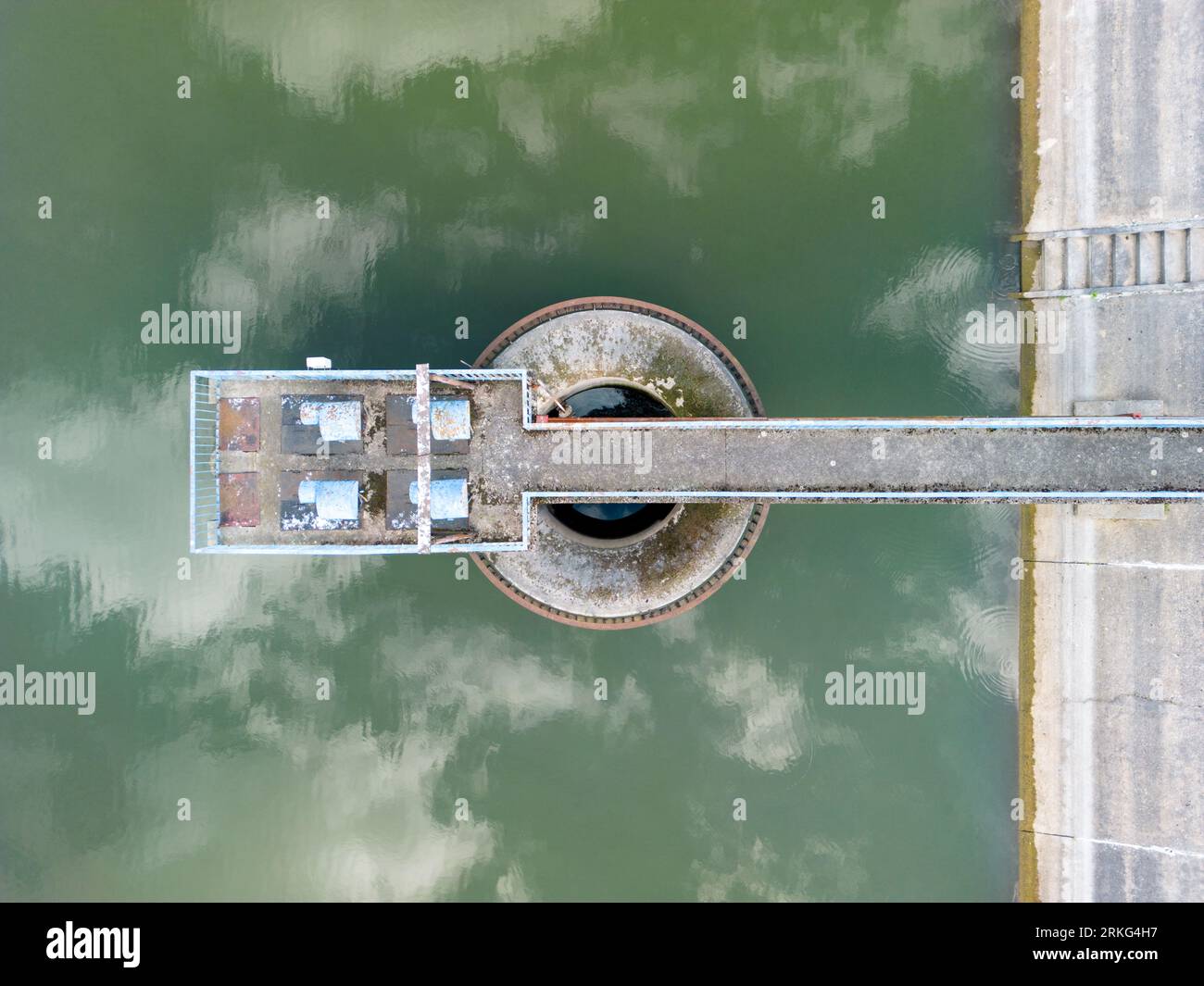 Aerial drone view of a concrete hydroelectric dam with a pump station ...