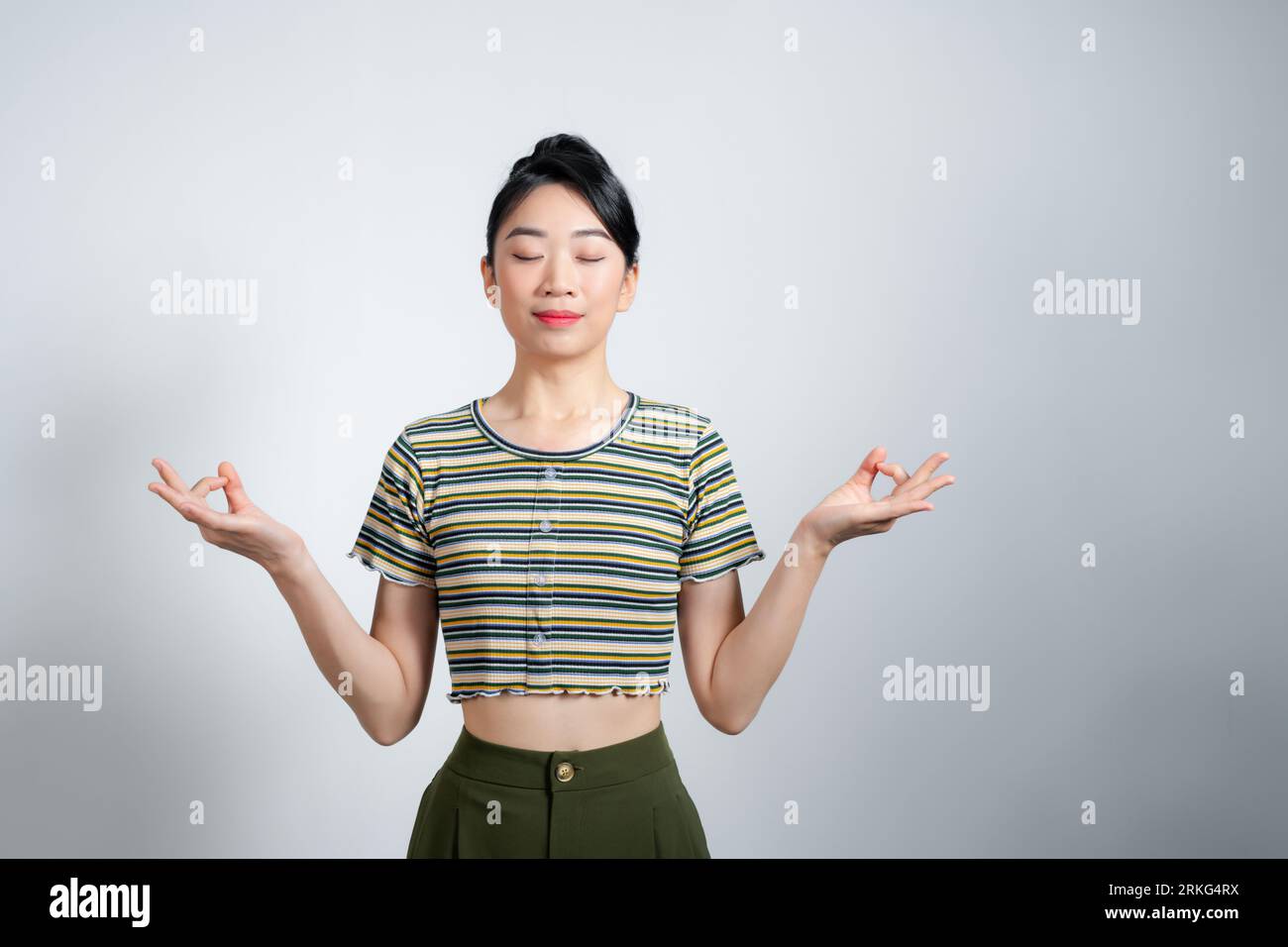Attractive asian woman gathers courage patience breathe air close eyes ...