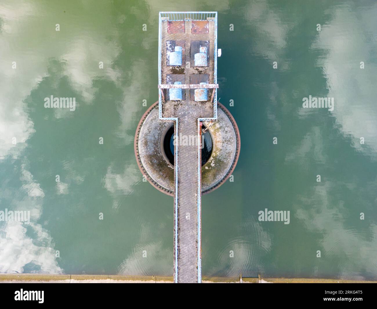 Aerial drone view of a concrete hydroelectric dam with a pump station ...