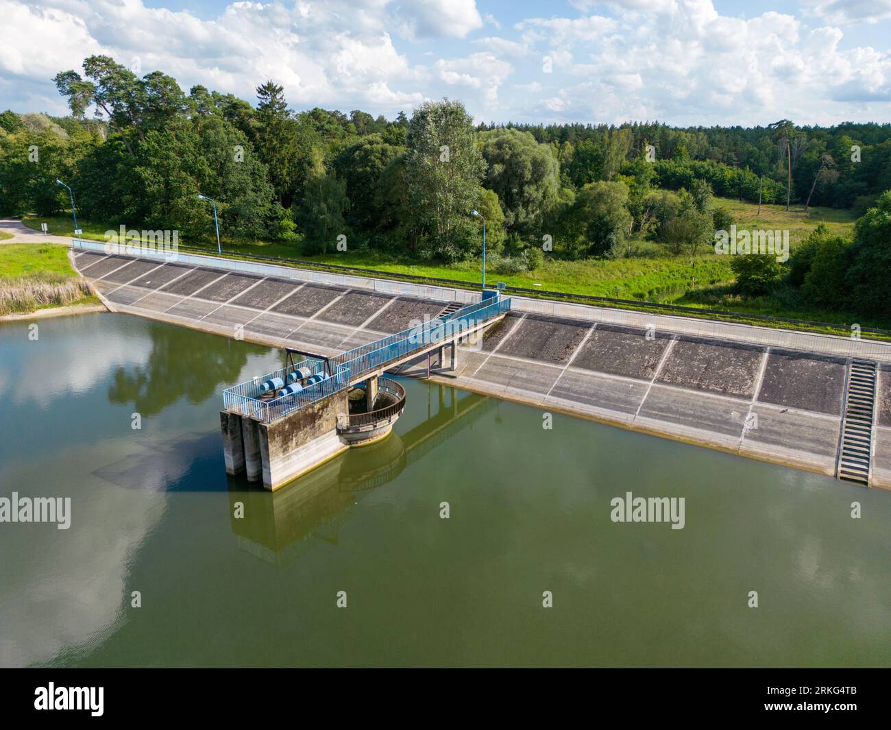 Aerial drone view of a concrete hydroelectric dam with a pump station ...