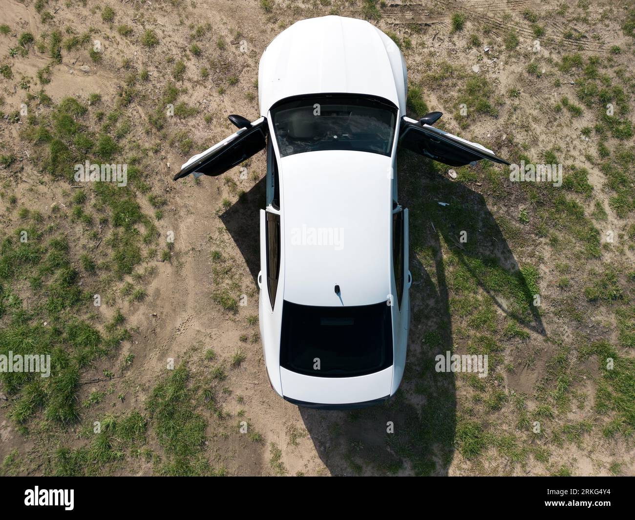 Am aerial drone view of a white car with open front doors Stock Photo ...