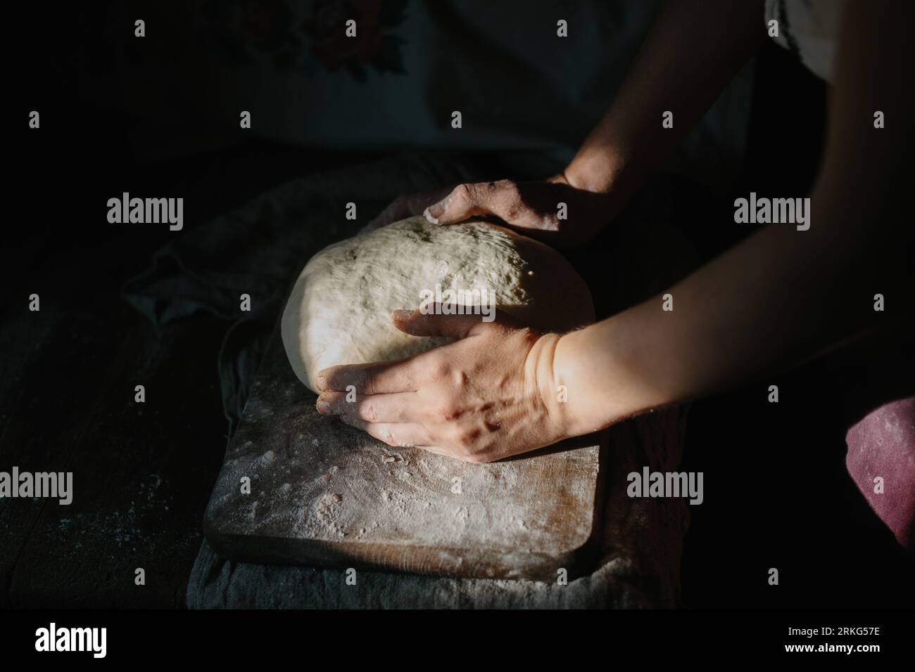 A woman in traditional Ukrainian clothing kneads bread dough Stock ...