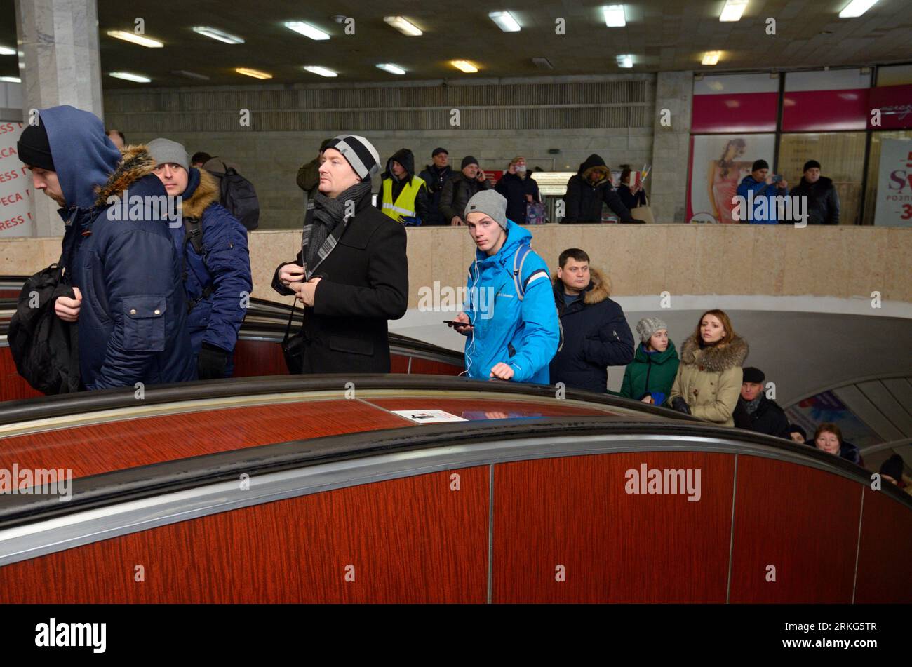 People passengers of metro riding on a subway escalator to the entrance ...