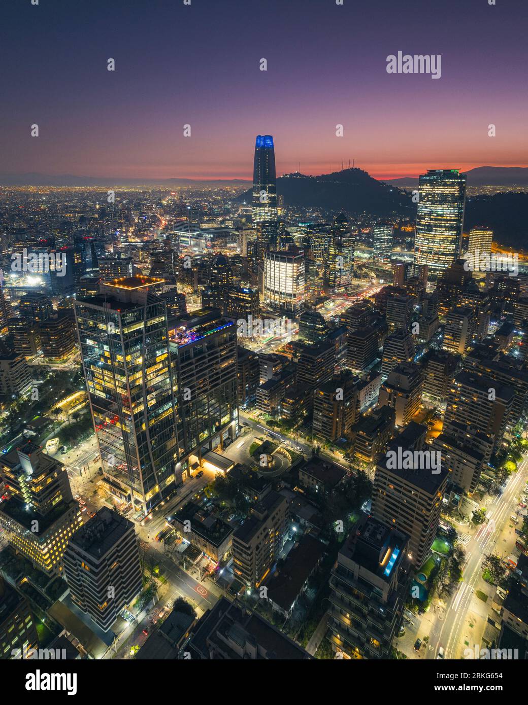 A vibrant urban skyline at night illuminated by a myriad of lights from ...