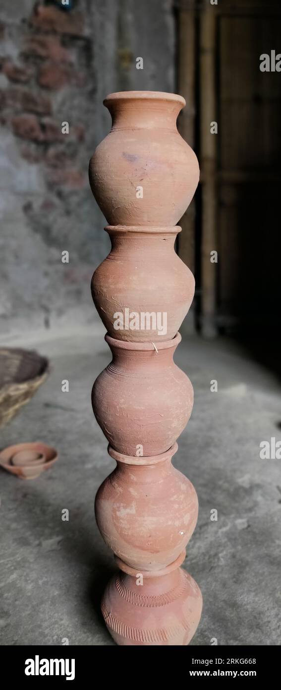 Multiple vibrant red ceramic vases sitting on top of each other on a ...